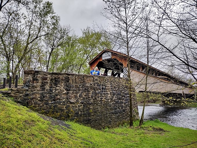 Even in early spring, visitors are drawn to the stone abutments and weathered wood of this enduring landmark.