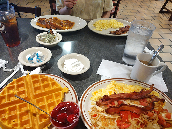 Breakfast spread that says "Today is going to be amazing" with golden waffles, scrambled eggs, and bacon performing a perfect morning symphony.
