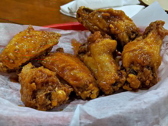 These glazed wings glisten like amber jewels, promising sticky-fingered satisfaction with every messy, delicious bite.