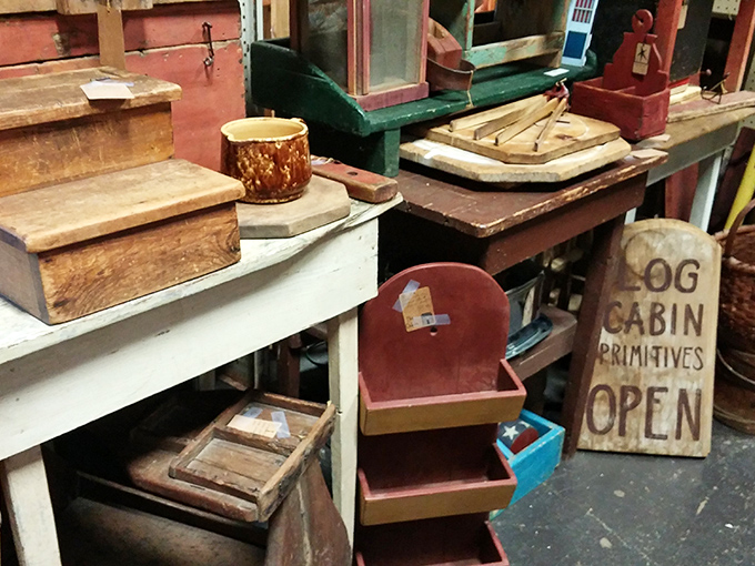 "Log Cabin Primitives Open" announces a sign among weathered wooden treasures that have outlived several generations of smartphones.