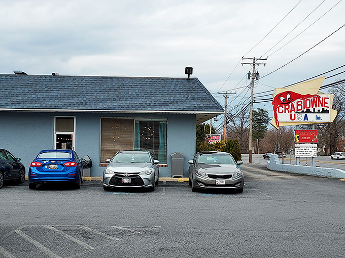 That cheerful blue building with the giant crab promises no-nonsense seafood in a place where locals feel right at home.