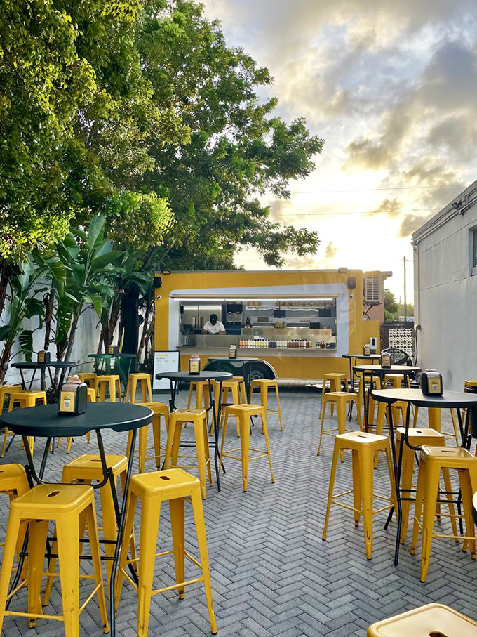 Diyon Hotdogs' bright yellow food truck creates an instant party atmosphere with matching stools and tropical vibes.