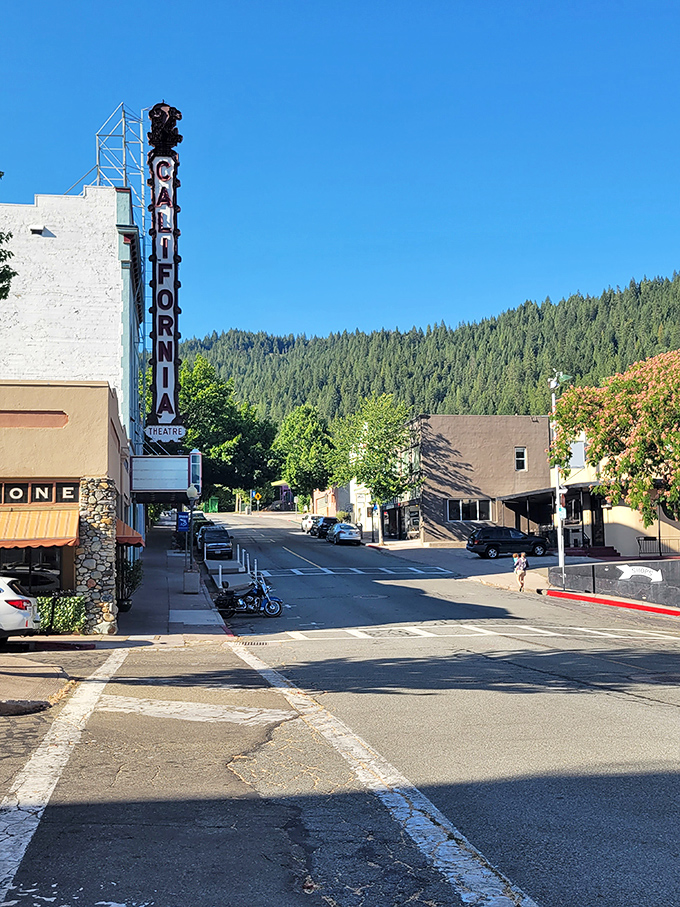 Uphill journey! Dunsmuir's California Theatre sign stands tall against a backdrop of emerald mountains, like a beacon calling you to small-town entertainment.
