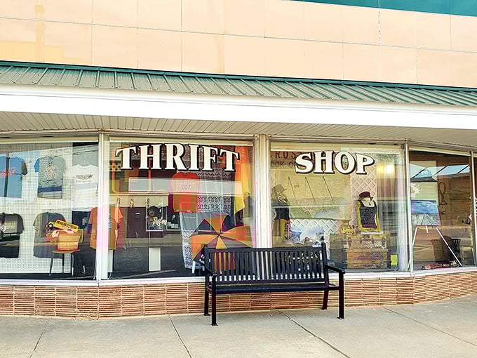 The classic "THRIFT SHOP" window display and sidewalk bench create small-town charm. That bench has heard countless "You'll never believe what I found inside" stories.