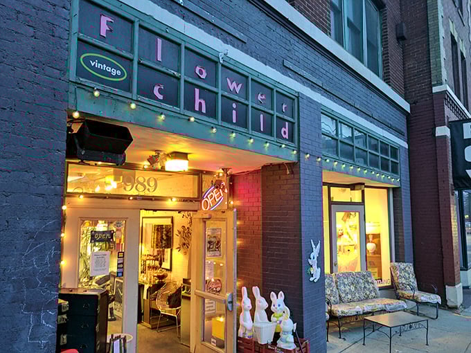 Flower Child Vintage glows with invitation, its string lights and colorful sign promising a journey through decades rather than mere shopping.