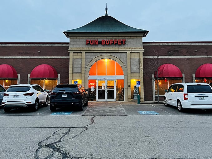 The warm glow from Fun Buffet's windows promises a cozy atmosphere where you can enjoy endless Asian favorites while the red maple adds a touch of seasonal beauty.
