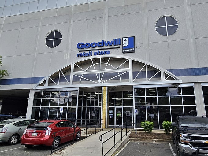 Goodwill's distinctive curved entrance welcomes shoppers into a world of organized, reliable thrift store excellence.