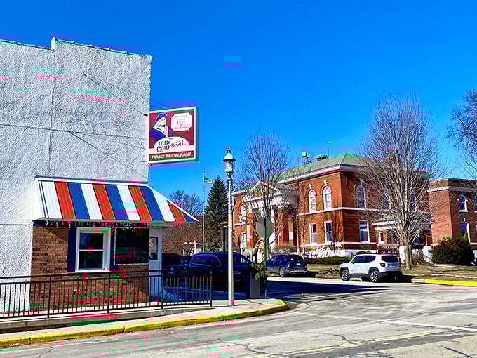 Brown buildings shimmer by Green Lake, their rustic charm dancing with sunlight like a scene straight from a cozy movie set.