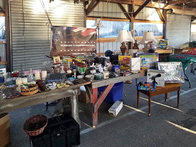 Makeshift counters overflow with the artifacts of American life. The "Homeless to Independence" banner hints at the market's community-minded spirit.