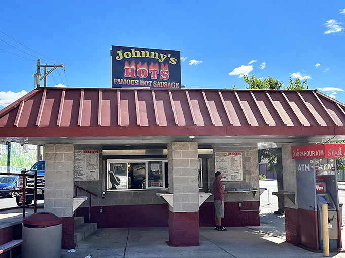 Johnny's Hots stands like a temple to hot sausage under that brilliant blue Philadelphia sky. The walk-up windows mean you're never far from satisfaction.
