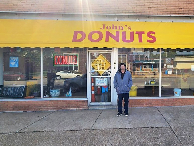 John's Donuts' cheerful yellow awning brightens the street like the smile you'll have after trying their fritters.