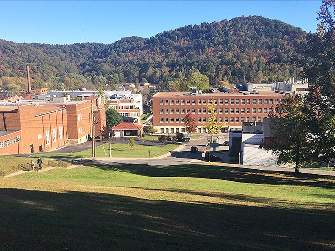Downtown Morehead nestled against rolling Kentucky hills, where brick buildings and autumn colors create a postcard-perfect small-town scene.