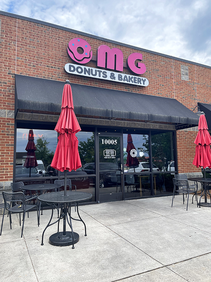 Pink branding and outdoor seating create the perfect stage for donuts that truly deserve their "OMG" reputation.