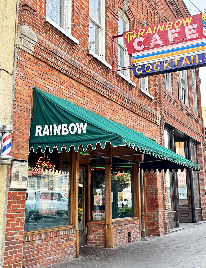 The Rainbow Cafe's vintage neon beckons like a lighthouse for hungry souls seeking authentic diner comfort.