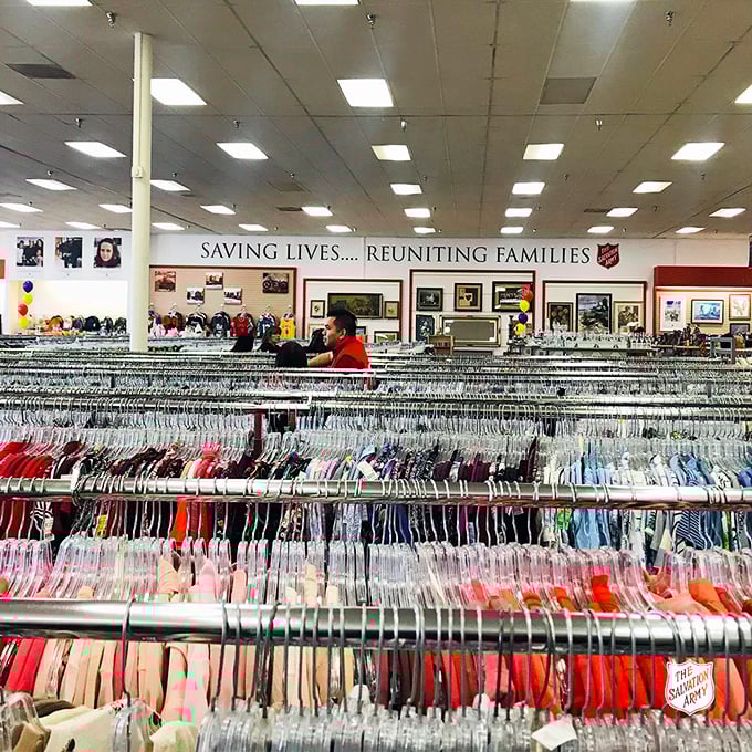 "Saving Lives... Reuniting Families" &ndash; The Salvation Army's mission statement hangs above a rainbow of organized clothing.