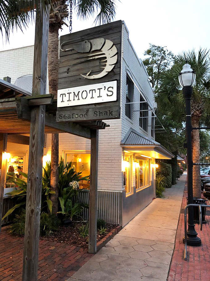 Timoti's crisp white exterior and wooden sign offer a modern take on the classic seafood shack experience.