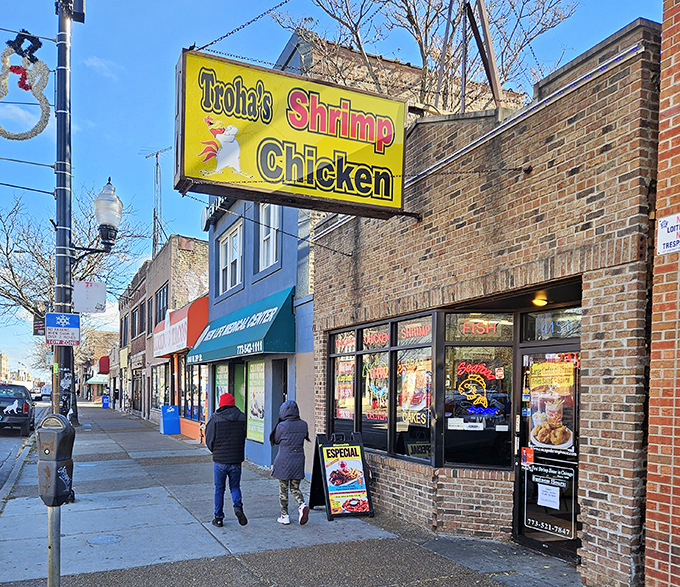 Troha's bright yellow sign cuts through urban noise like a dinner bell for seafood lovers.