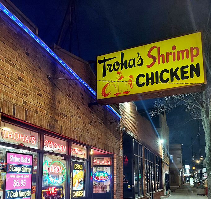 Troha's bright yellow sign cuts through the night &ndash; a neon promise of crispy, golden seafood treasures within.