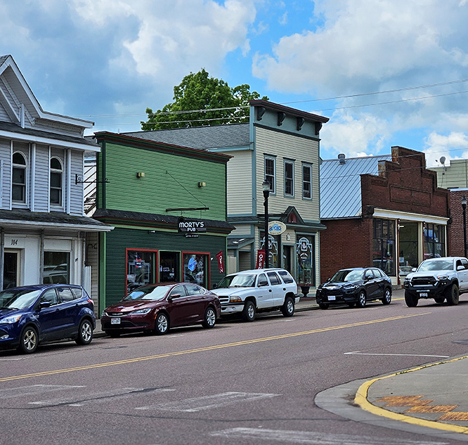 Colorful storefronts line up like old friends gathering for their daily neighborhood chat.