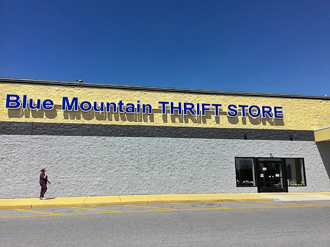 The bright yellow wall of Blue Mountain Thrift Store practically shouts "Sunshine deals inside!"
