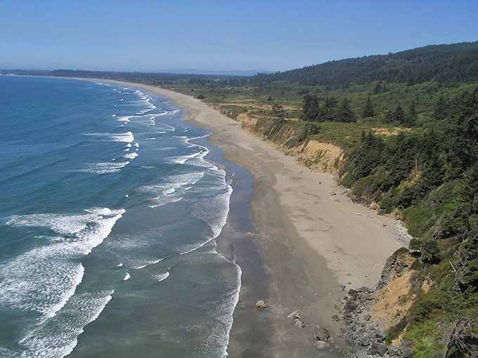 Crescent City's sun-drenched dunes and bridge create a postcard-perfect scene that whispers, "Retirement goals achieved!"