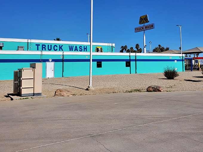 That turquoise truck wash pops like a vintage postcard against endless Arizona sunshine.