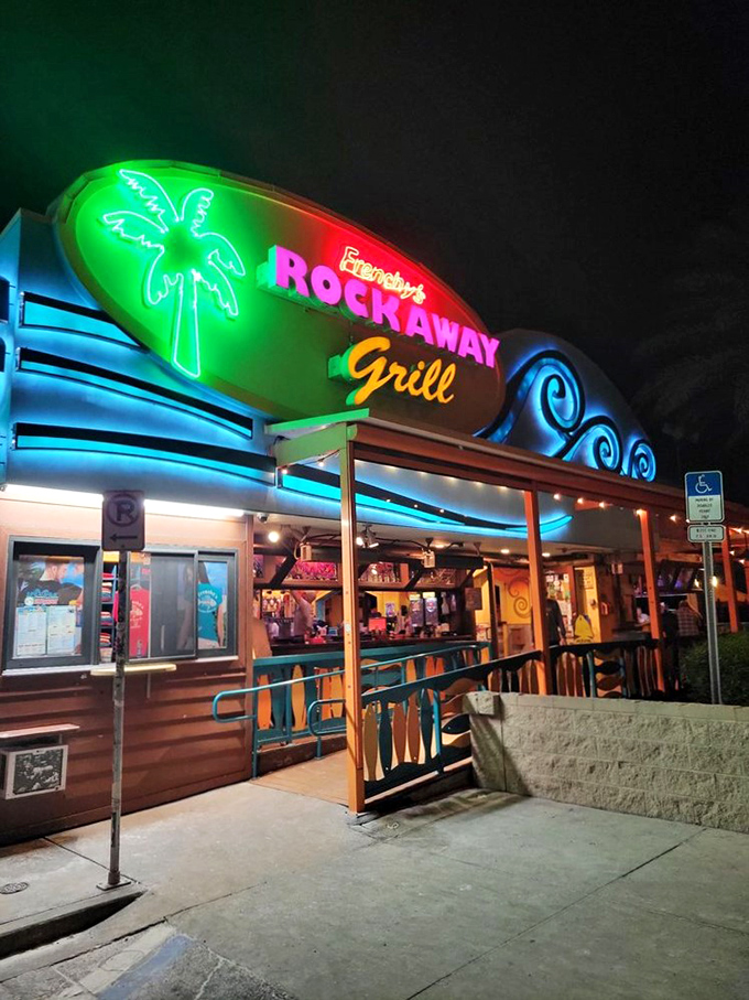By night, Frenchy's neon glow transforms into a beacon for hungry beachgoers seeking grouper sandwich perfection.