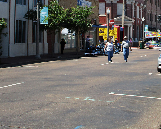 Street festival vibes in Greenwood where bounce houses and oyster signs promise entertainment without breaking budgets.