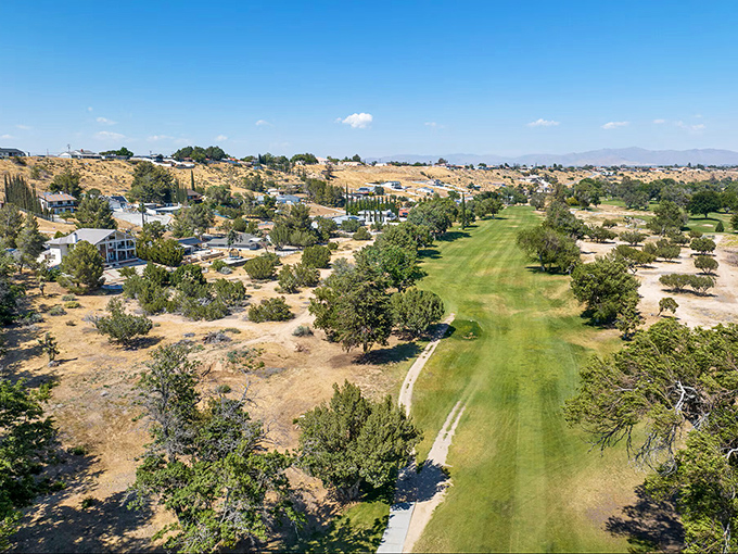 That emerald fairway cuts through Hesperia's desert palette like a cool oasis&mdash;where retirement means choosing between golf clubs and hiking boots daily.
