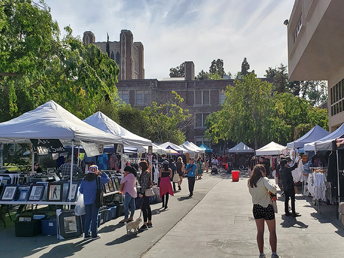 Shoppers stroll through Los Feliz Flea's orderly rows, where each white tent holds potential for the perfect discovery.