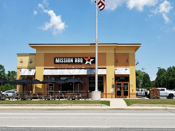 That yellow facade and patriotic mission create an atmosphere where great food meets American pride.