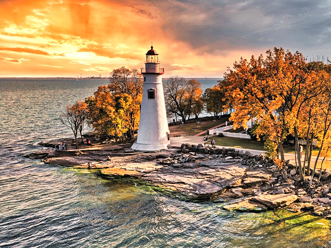 Sunset transforms Marblehead Lighthouse into a painting come to life, with autumn trees framing this iconic Lake Erie landmark.