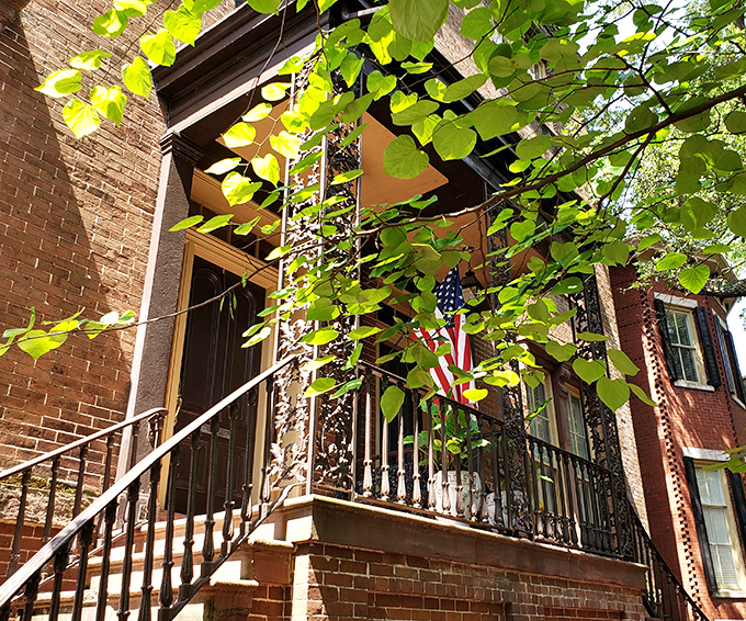 Brick steps lead to boarding house bliss - where strangers become family over shared platters.