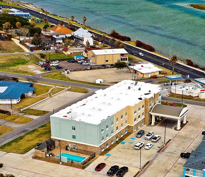 The Texas coast at Rockport stretches endlessly, where salt air and seagulls create nature's perfect soundtrack.
