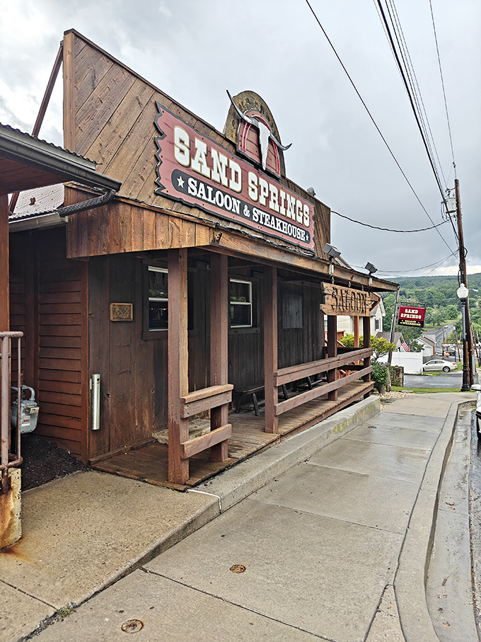 The wooden facade of Sand Springs promises an authentic experience&mdash;like stepping into a frontier saloon where the steaks are the real gold.
