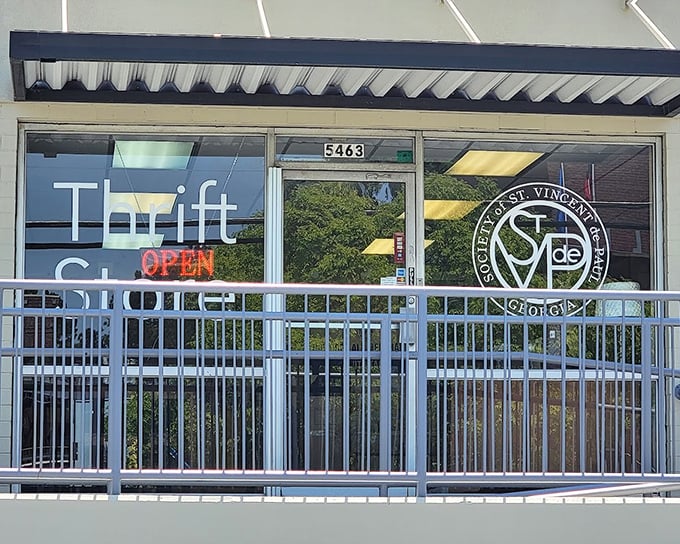 This cheerful thrift shop glass door and window display invites you in for some serious bargain-hunting adventures.