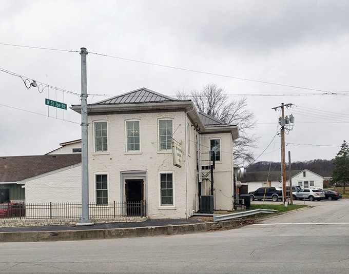 This simple white building along the highway serves as a beacon for travelers seeking perfect fried chicken.