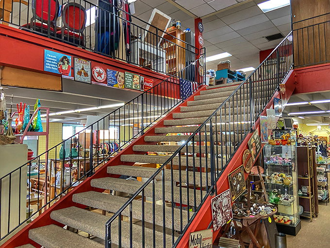 The red staircase beckons explorers to the second floor, where additional treasures await those willing to climb toward antiquing enlightenment.
