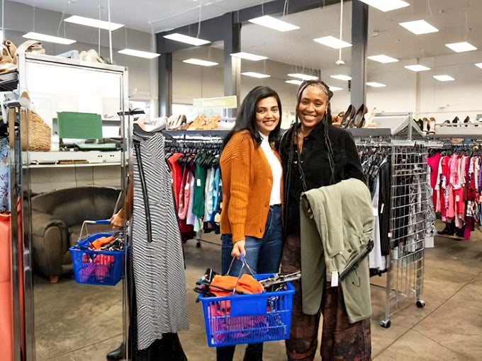 Happy hunters with full baskets&mdash;the universal sign of a successful expedition into the wilds of secondhand shopping. Their smiles say it all: mission accomplished.