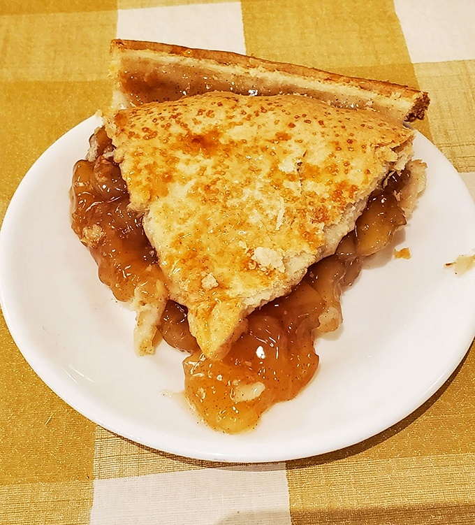 This isn't just apple pie; it's edible Americana with a crust crimped by hands that understand the gravity of dessert responsibility.