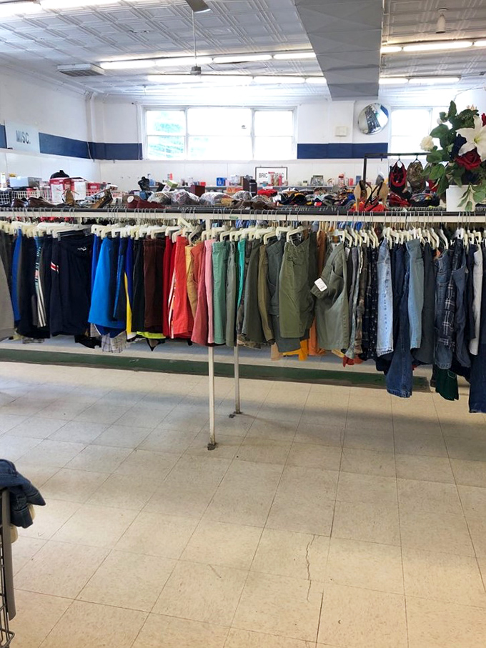 A rainbow of possibilities arranged with surprising precision. The men's section offers everything from work pants to vacation shorts, all waiting for second chances.