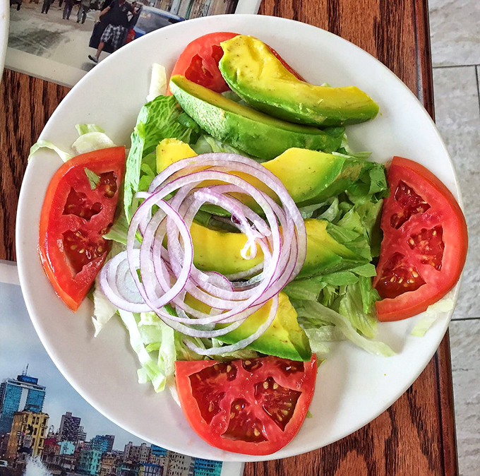 A symphony in green and red&mdash;this avocado and tomato salad offers a refreshing counterpoint to Cuba's heartier classics.