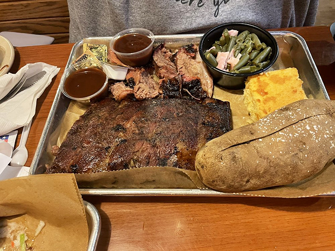 A barbecue platter that means business &ndash; smoke-ringed brisket, tender pork, green beans, and cornbread that's ready for its close-up.