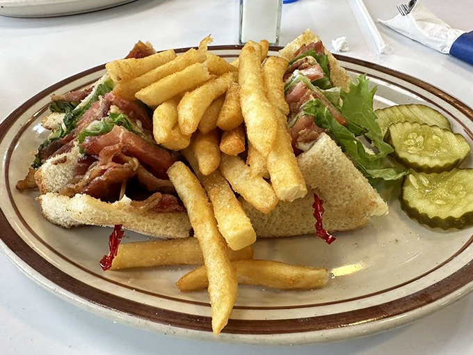 The club sandwich stands tall and proud, surrounded by a golden honor guard of perfectly crisp french fries&mdash;a lunch worthy of salutation.