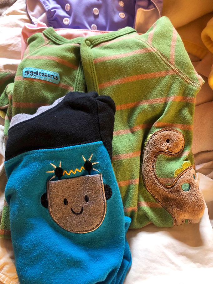 Adorable onesies with personality! These dinosaur and robot designs prove secondhand baby clothes can be first-rate in cuteness.
