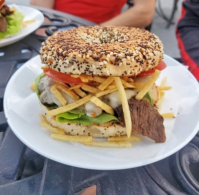 This isn't just a bagel sandwich&mdash;it's an architectural marvel of seeds, meat, and veggies that somehow defies gravity and good manners.