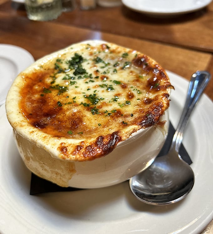 This isn't just onion soup &ndash; it's a comfort food masterpiece with a crown of melted cheese that stretches dramatically with each spoonful.