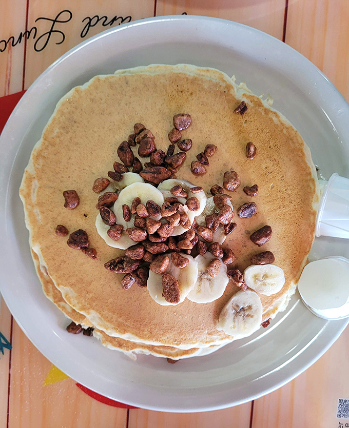 Banana pancakes topped with pecans &ndash; like a warm hug from your grandmother, if your grandmother was an award-winning pastry chef.