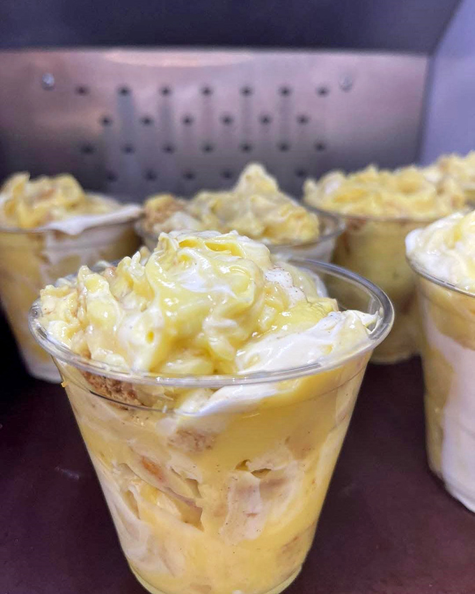 Banana pudding cups lined up like soldiers ready for dessert duty. Those vanilla wafers peeking through are calling my name!