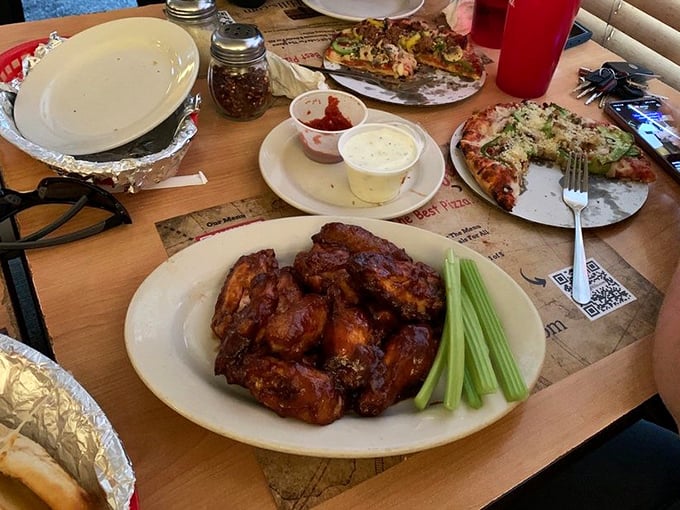 Wings and pizza on the table&mdash;nature's perfect pairing, like Astaire and Rogers but with more napkins required.